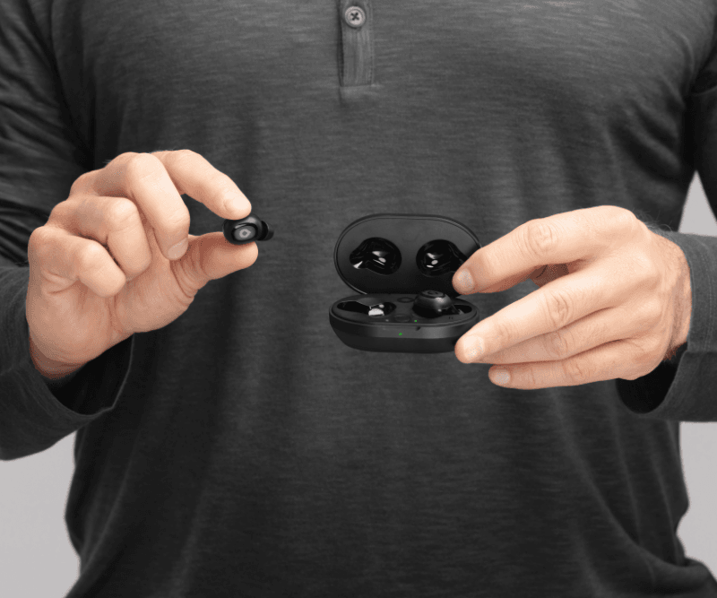 A close-up view of the Lexie H1 Hearing Buds in their rechargeable case ...